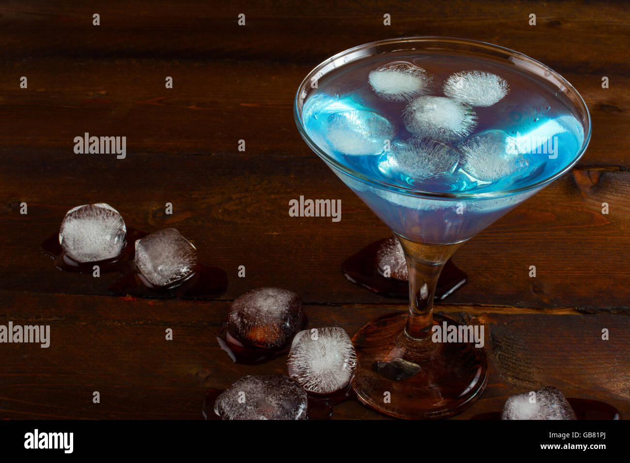 Iced blue cocktail on wooden background. Blue margarita. Blue ...