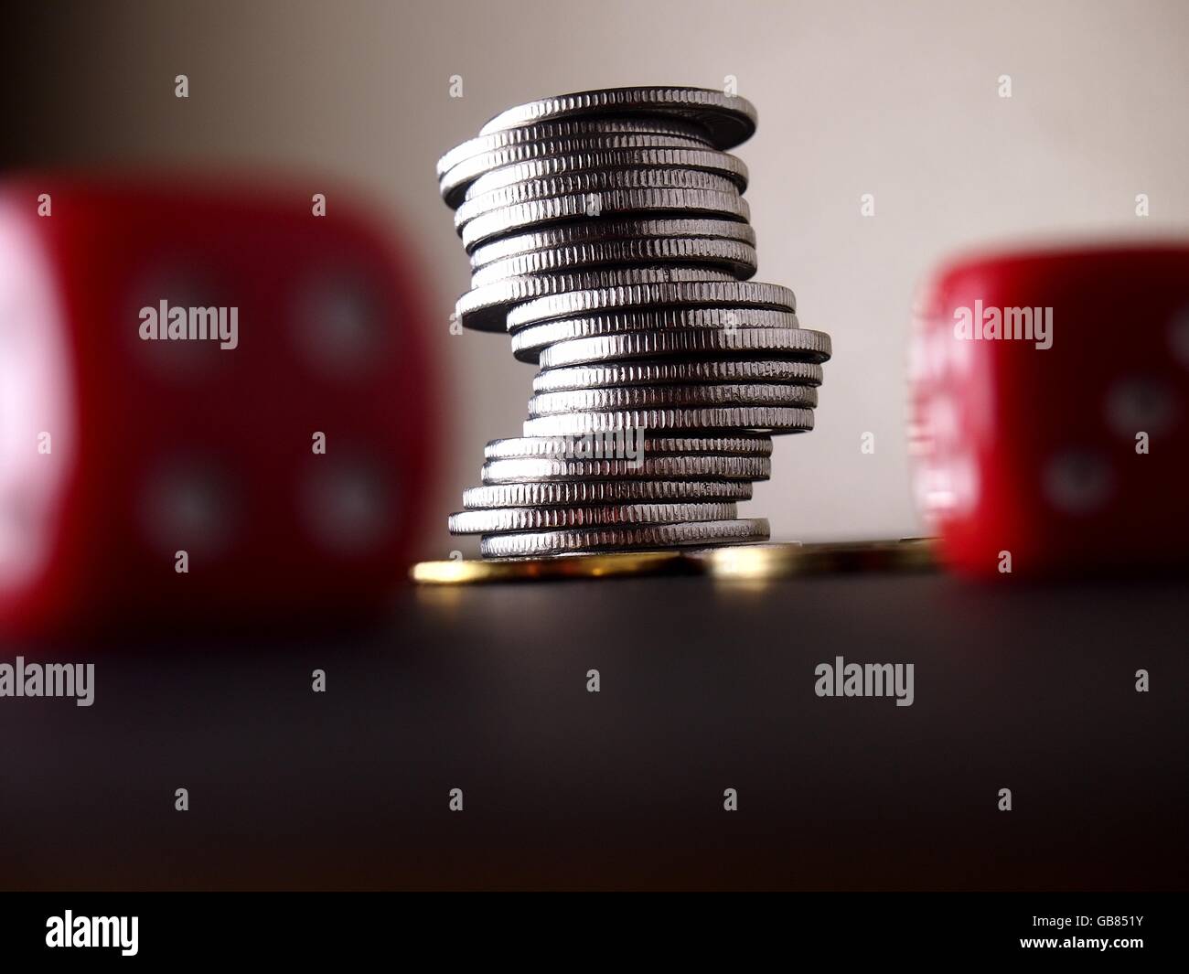 Two red dice, game cards and stack of coins Stock Photo - Alamy
