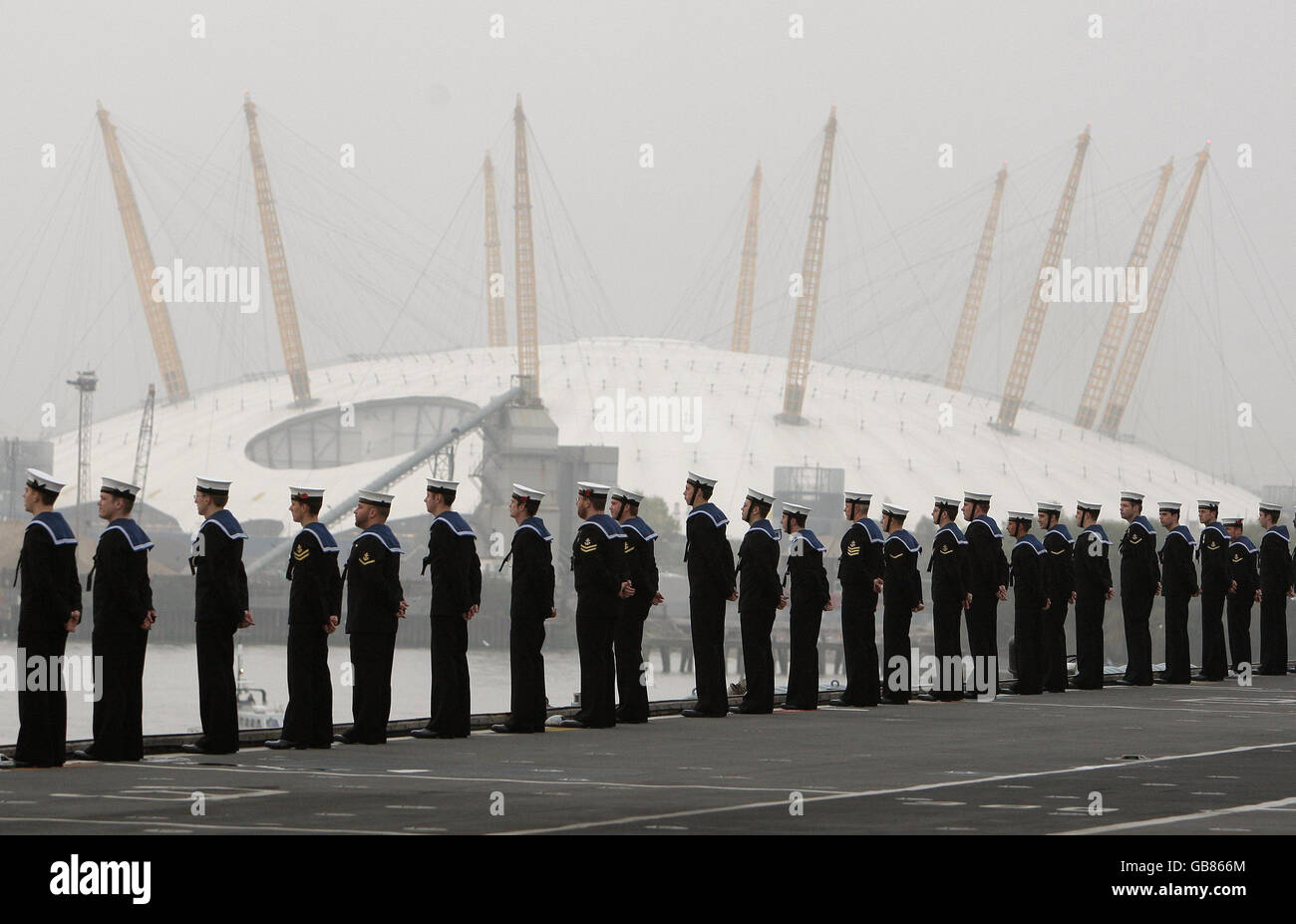 Royal Navy sailors stand on the deck of the aircraft carrier HMS ...