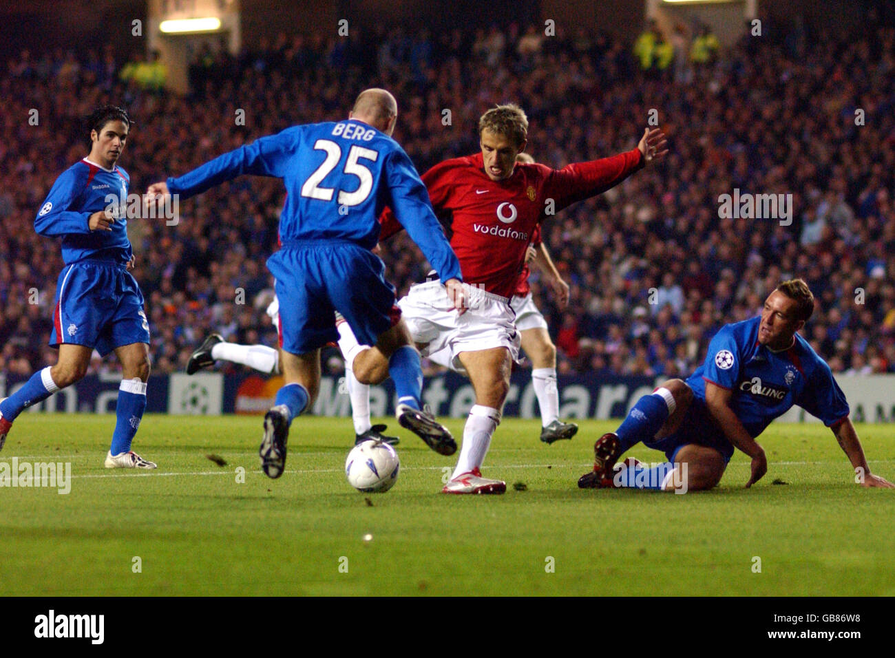 Manchester United' s Phil Neville gets between Rangers' Henning Berg ...