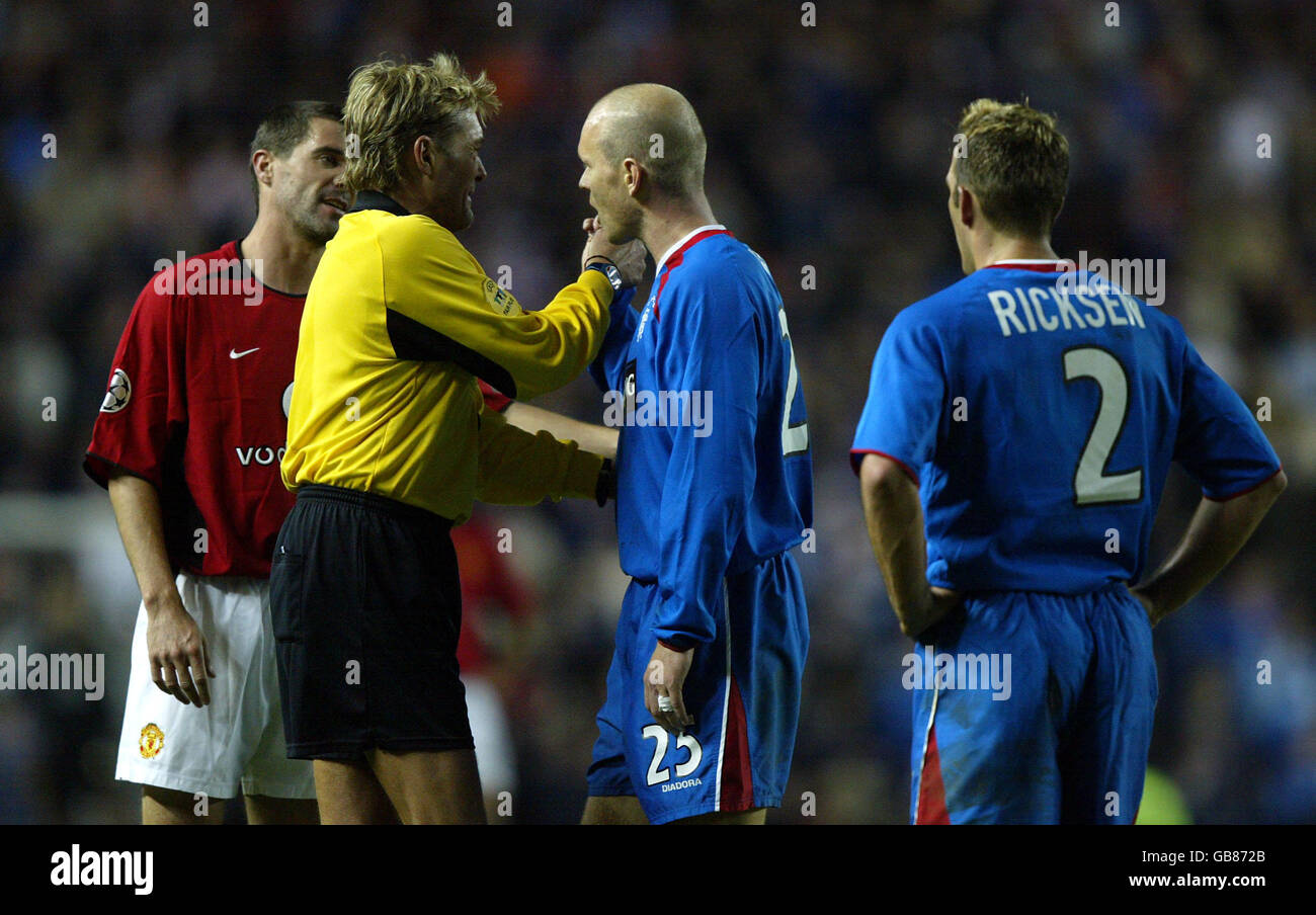 Rangers's Henning Berg has words with referee Anders Frisk as ...