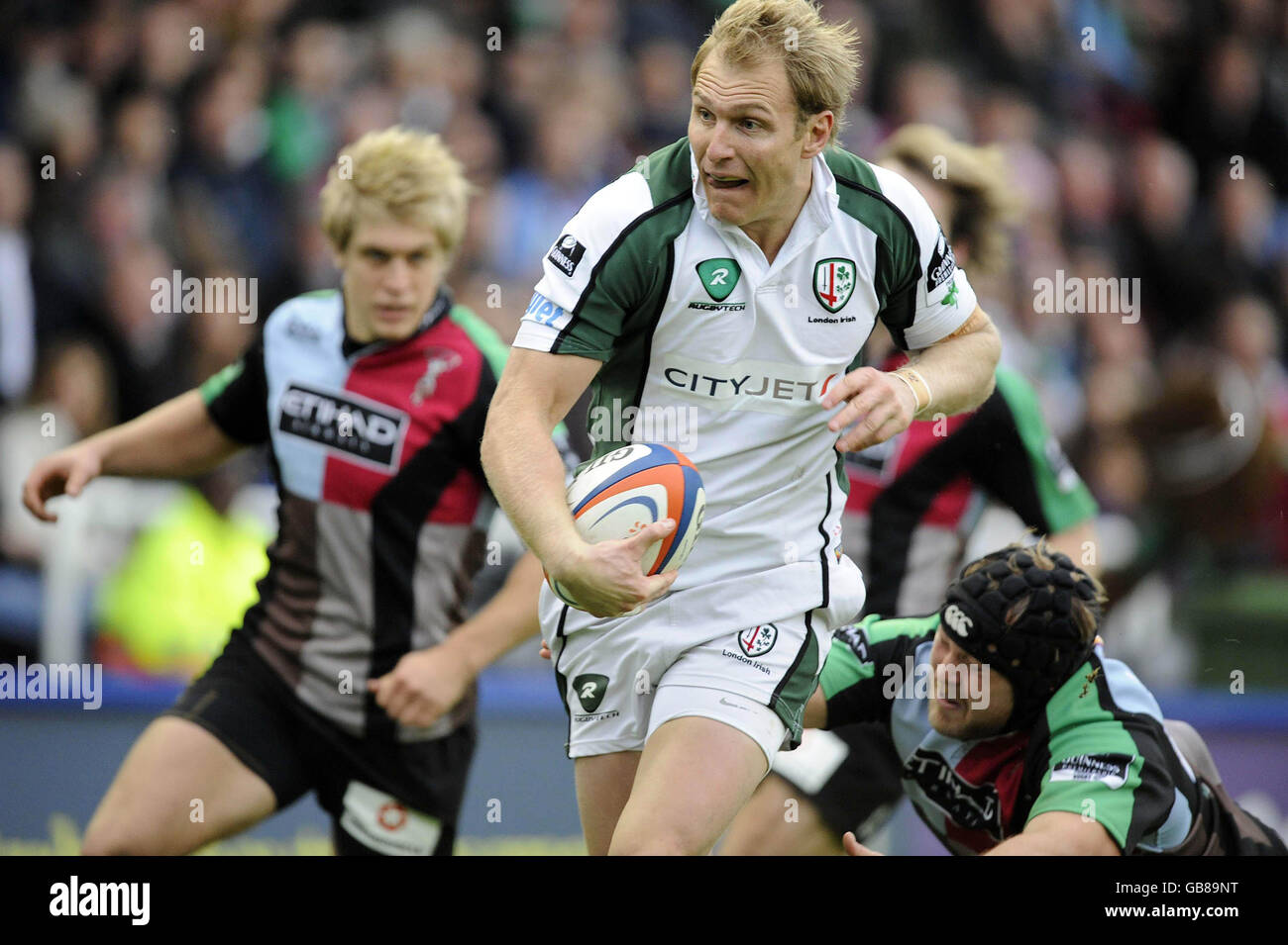 London Irish Peter Hewat breaks through the Harlequins defence to score ...
