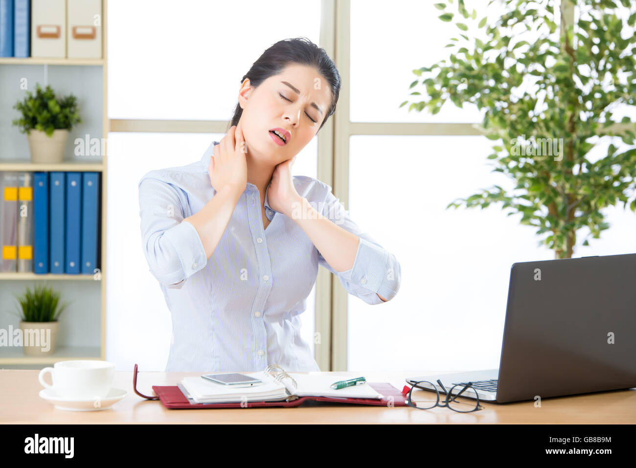 Young asian business woman with pain in neck in office Stock Photo - Alamy