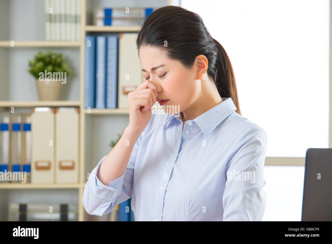 Young asian business woman with cold in office Stock Photo - Alamy