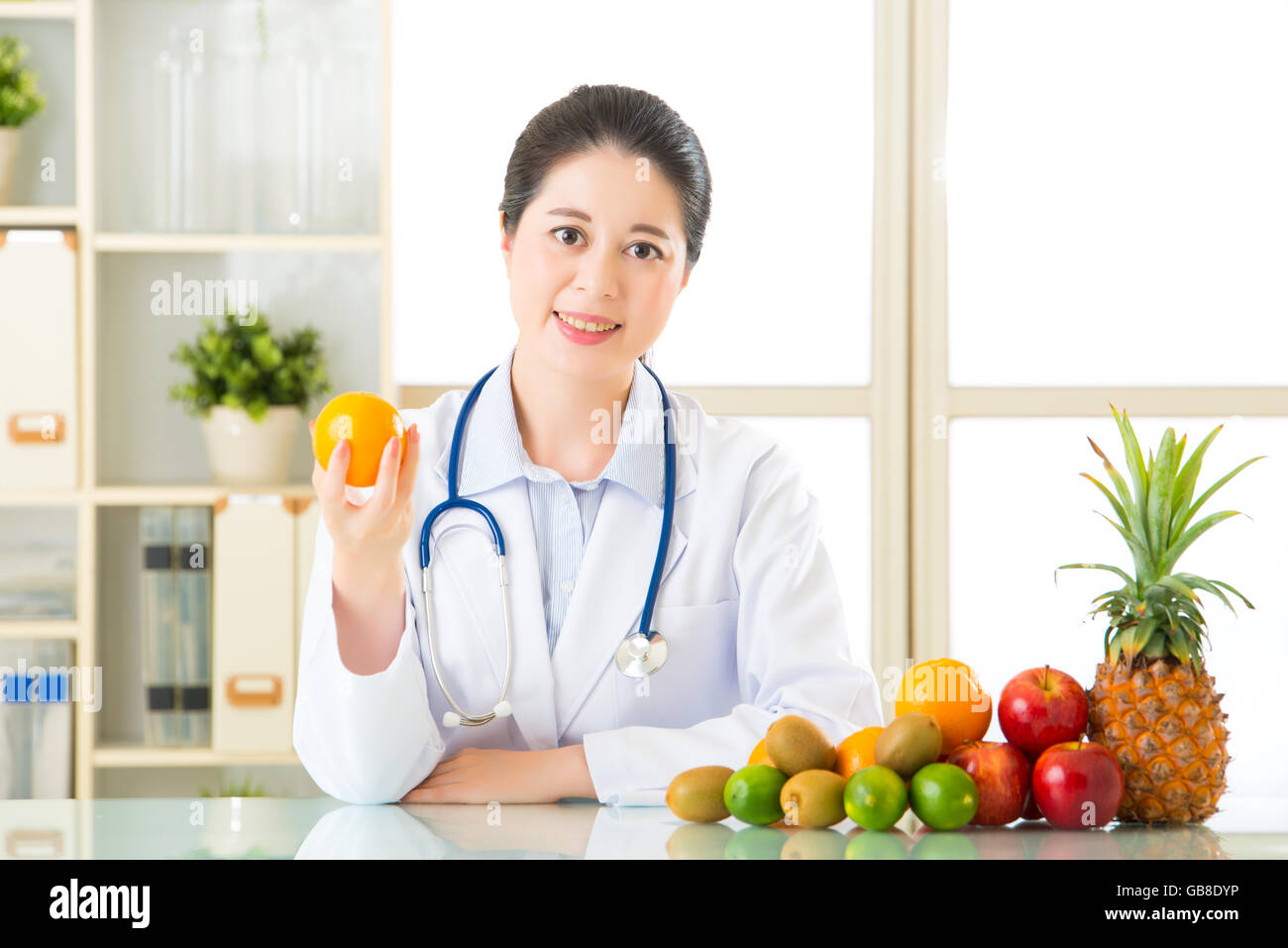 Doctor nutritionist with fruits, healthy eating Stock Photo - Alamy