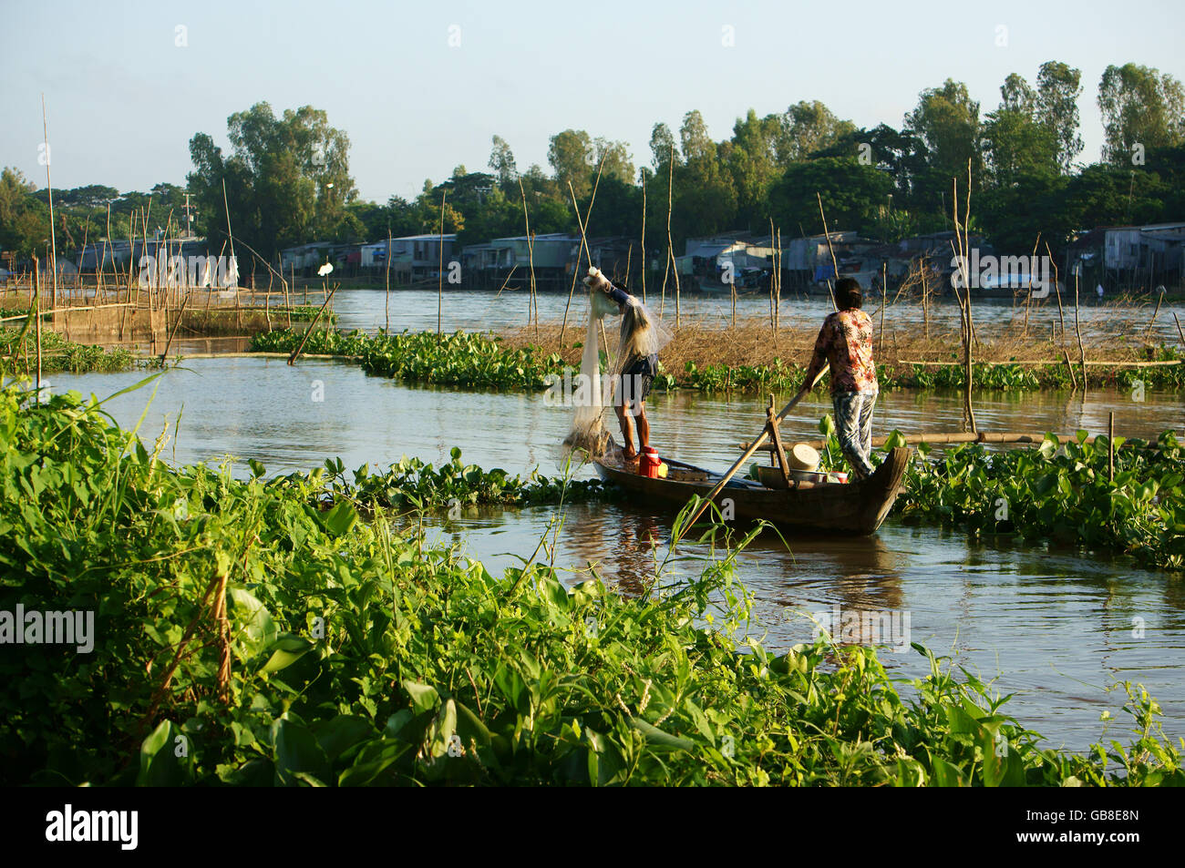 Couple of fisherman catch fish on river in flood season, the woman ...