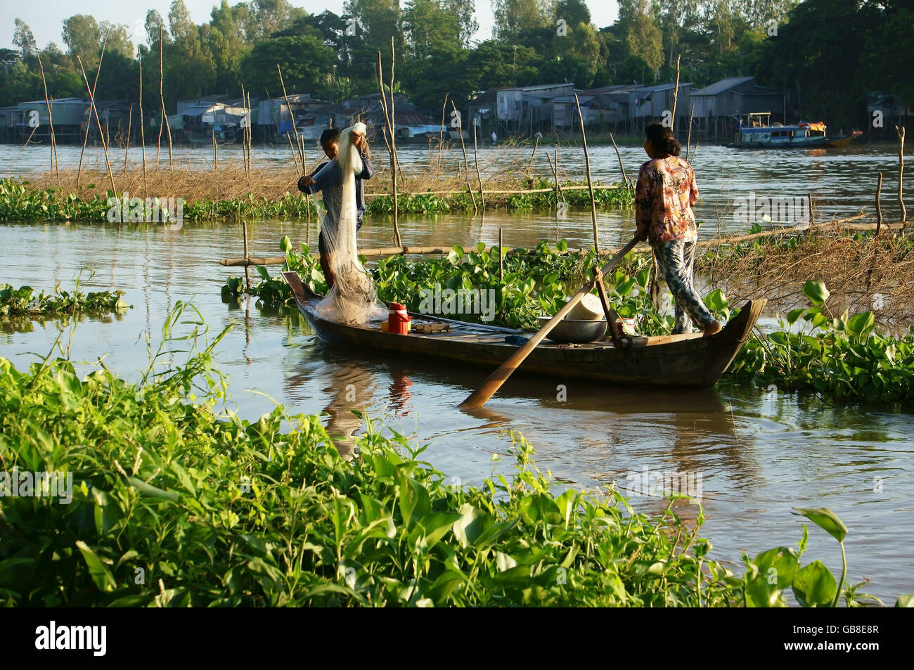 Couple of fisherman catch fish on river in flood season, the woman ...