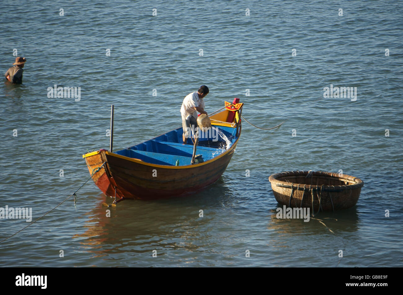 PHAN THIET, VIET NAM- FEB 3: Fisherman wash the hold of boat with water ...