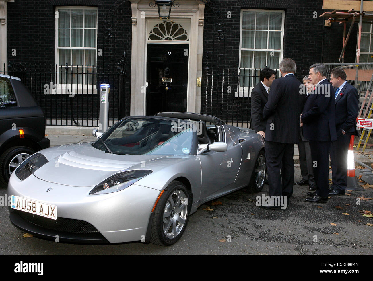 Prime Minister Gordon Brown looks at the Tesla Roadster, an electric ...
