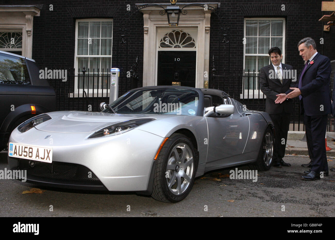 Prime Minister Gordon Brown looks at the Tesla Roadster, an electric ...