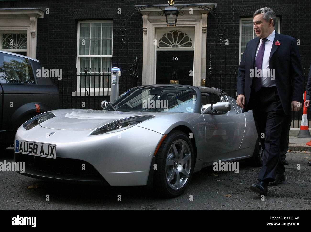 Prime Minister Gordon Brown looks at the Tesla Roadster, an electric ...