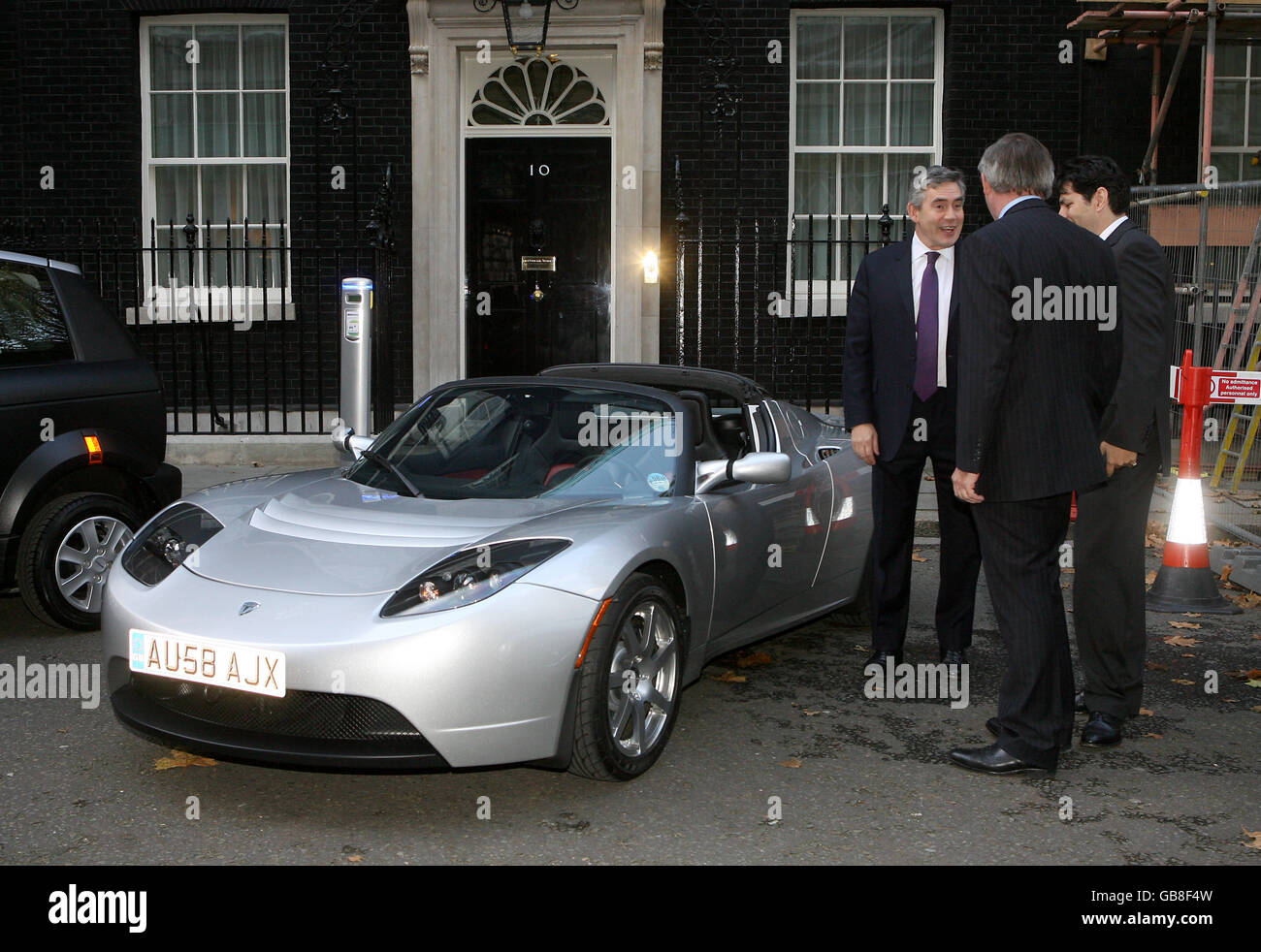 Prime Minister Gordon Brown looks at the Tesla Roadster, an electric ...