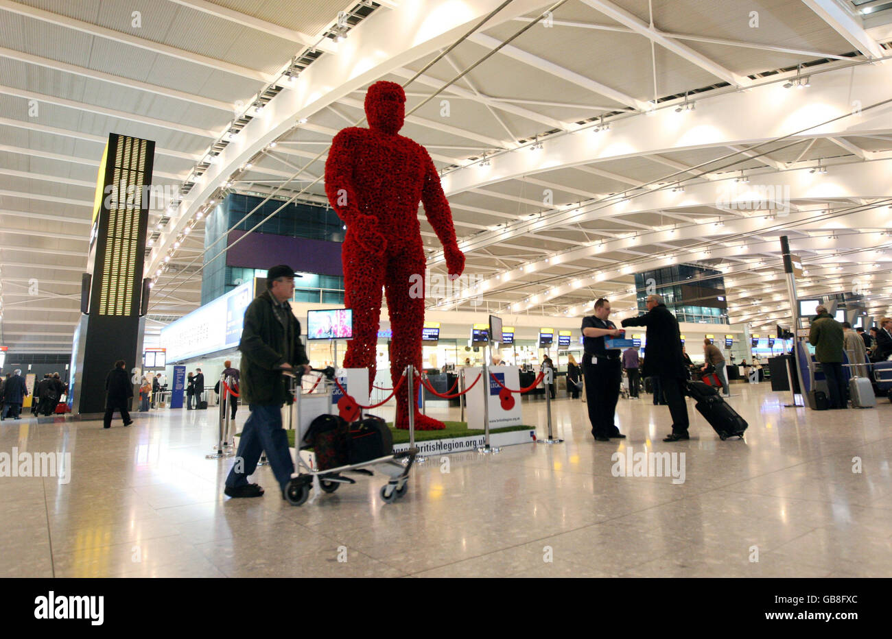 A 7 metre tall 'Poppy Man' in the departures area of Terminal 5 at ...