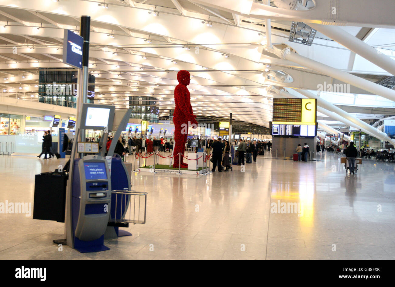 A 7 metre tall 'Poppy Man' in the departures area of Terminal 5 at ...