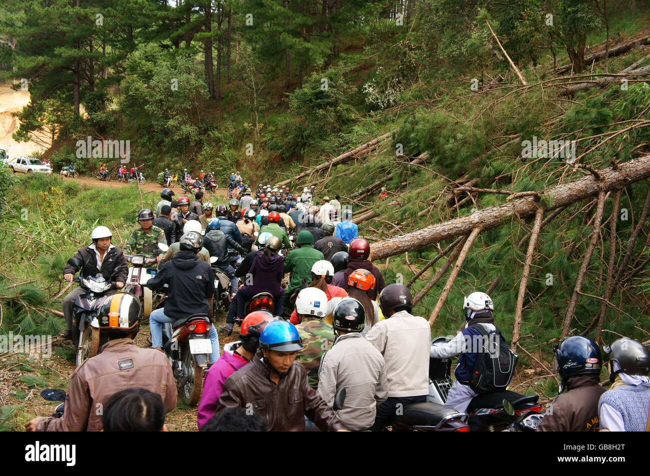 Crowd of people wear helmets ride motorbike wait on mountain pass ...