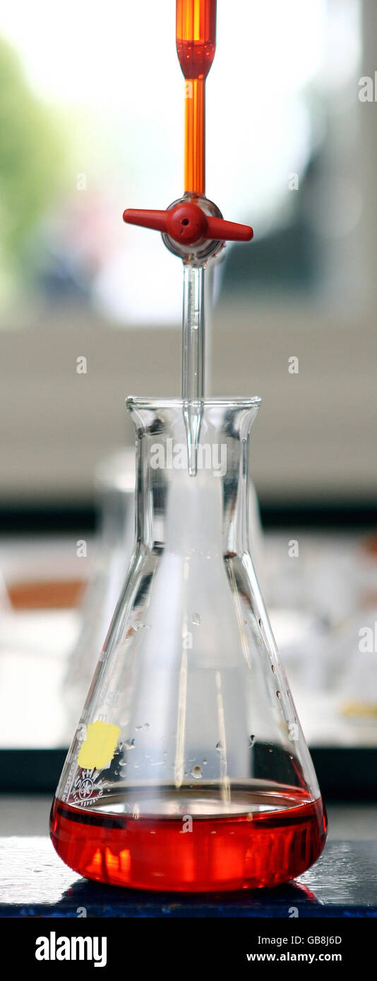 General view of a red liquid dripping into a Pyrex beaker during some ...