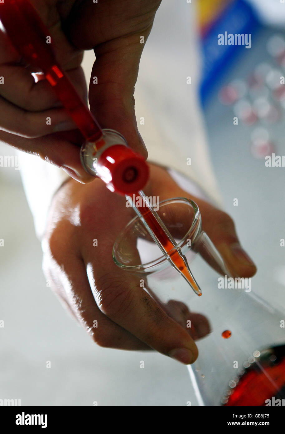 General view of a red liquid dripping into a Pyrex beaker during some ...