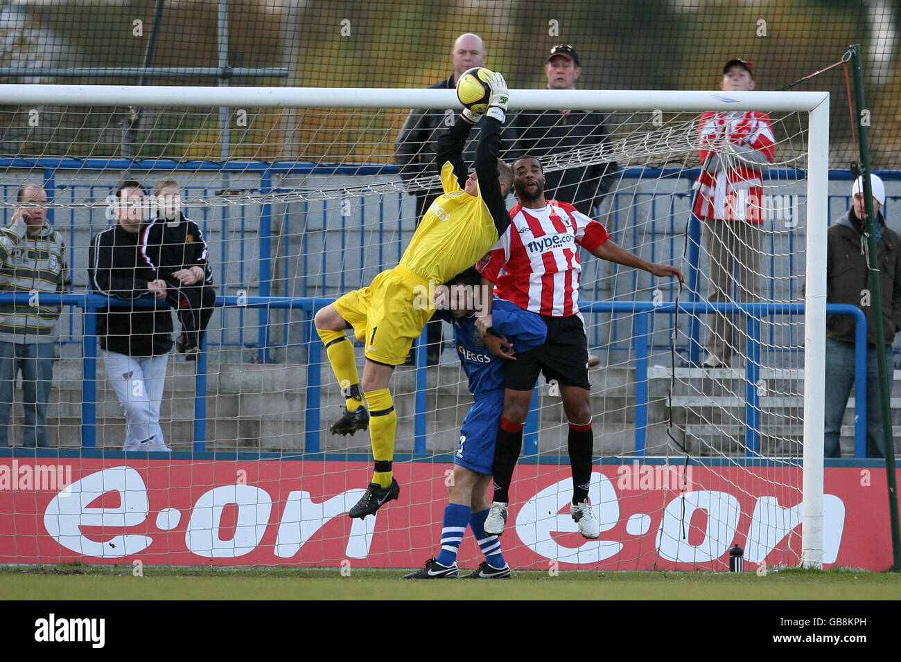 Exeter City's Richard Logan (right) and Curzon Ashton goalkeeper David ...