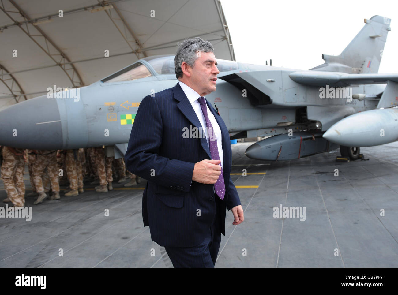 Prime Minister Gordon Brown walks past an RAF Tornado at Al Udeid air ...