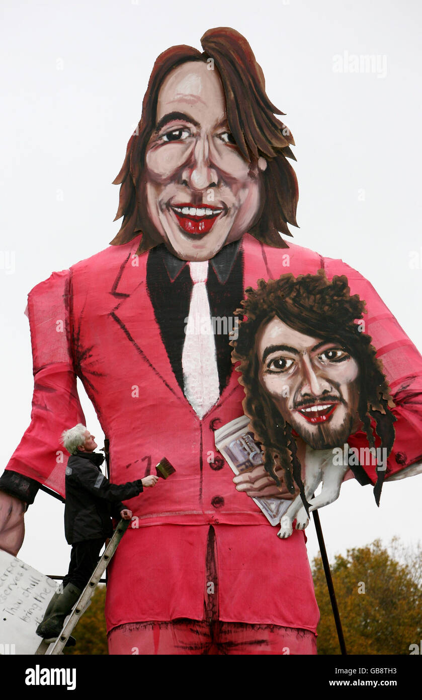 Artist Frank Shepherd puts the finishing touches to an effigy of ...