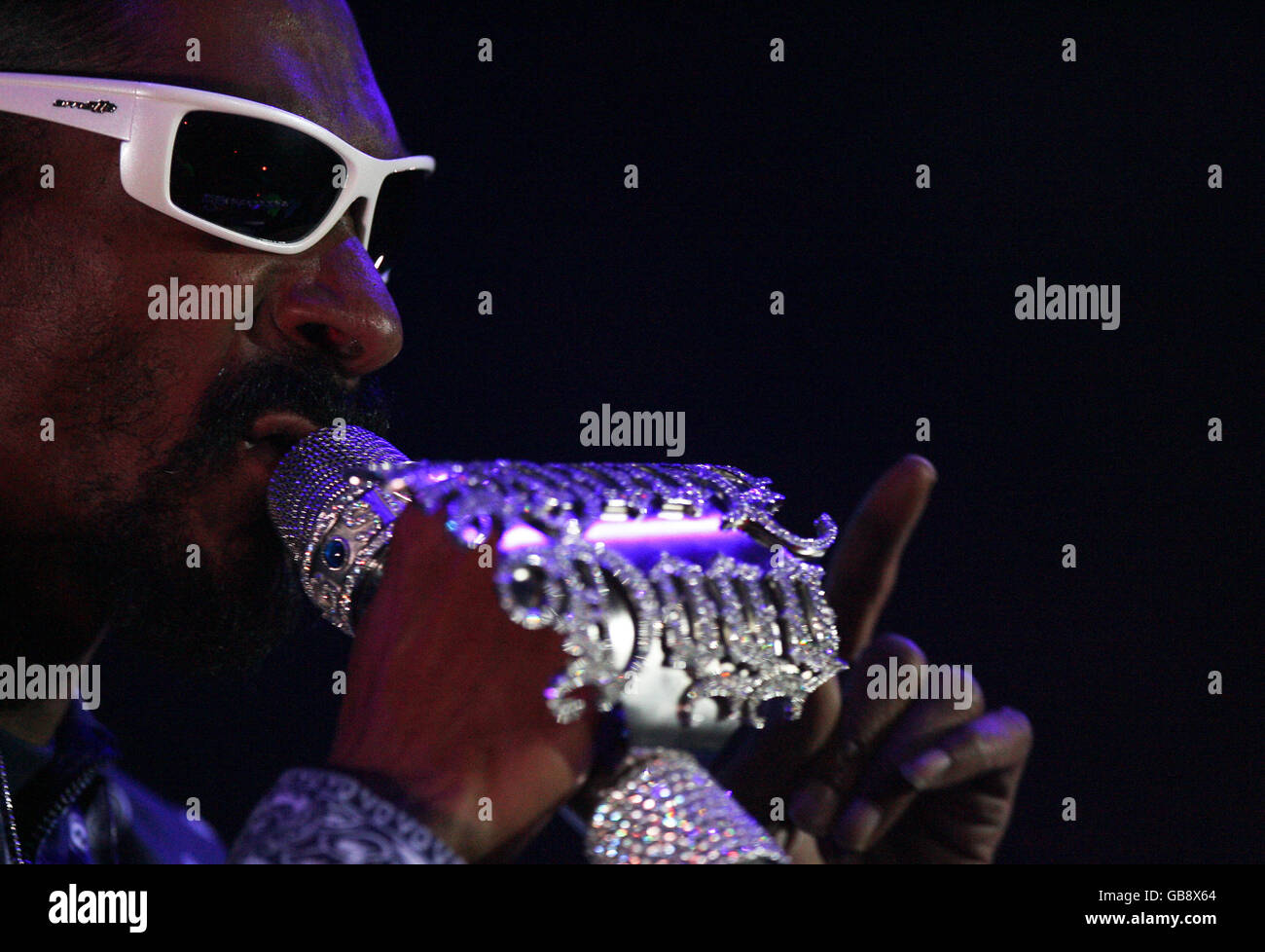 Snoop Dogg holds a diamond encrusted microphone as he performs at the ...