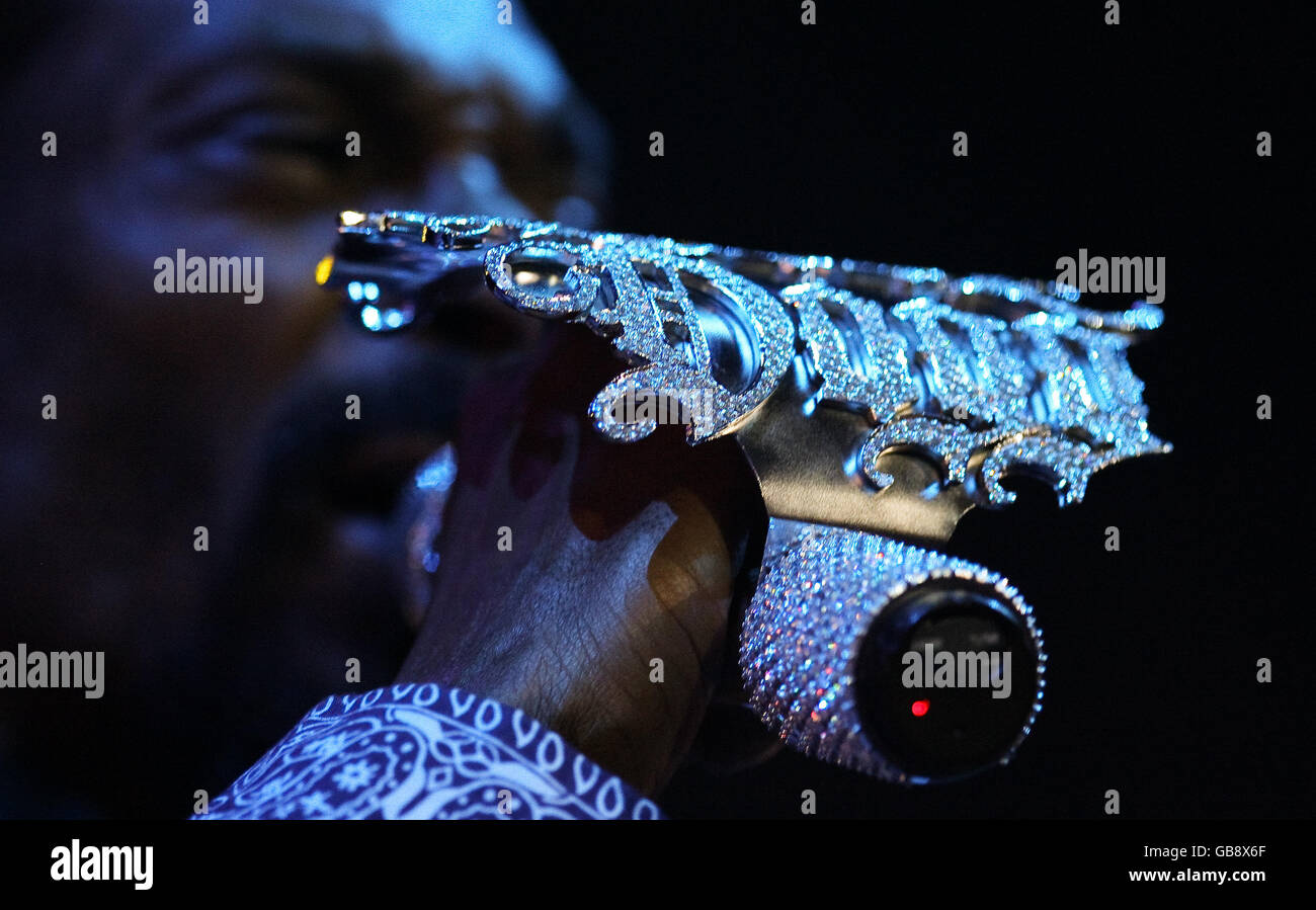 Snoop Dogg holds a diamond encrusted microphone as he performs at the ...