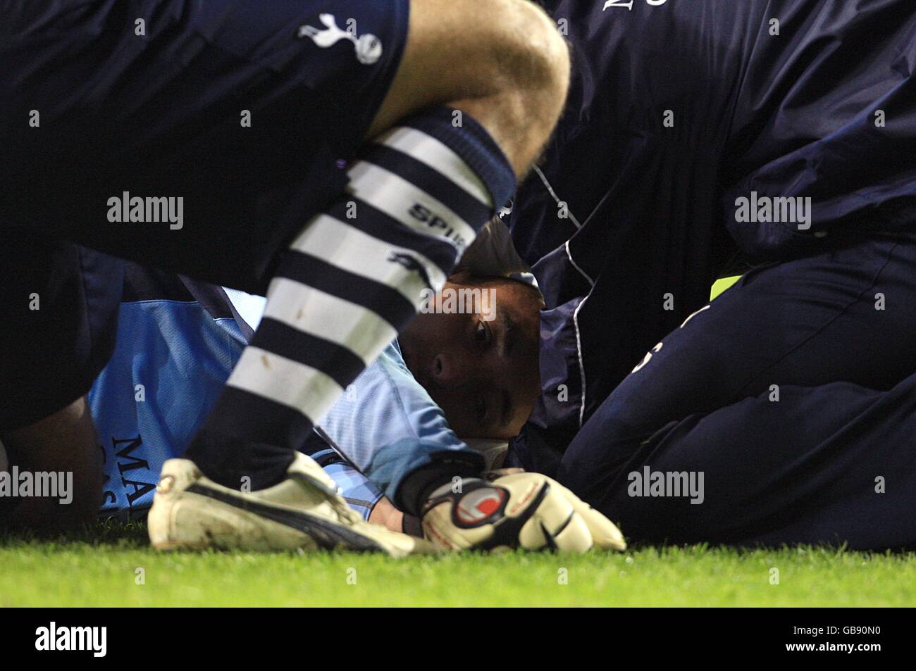 Tottenham Hotspur goalkeeper Heurelho Gomes is treated by medical staff ...