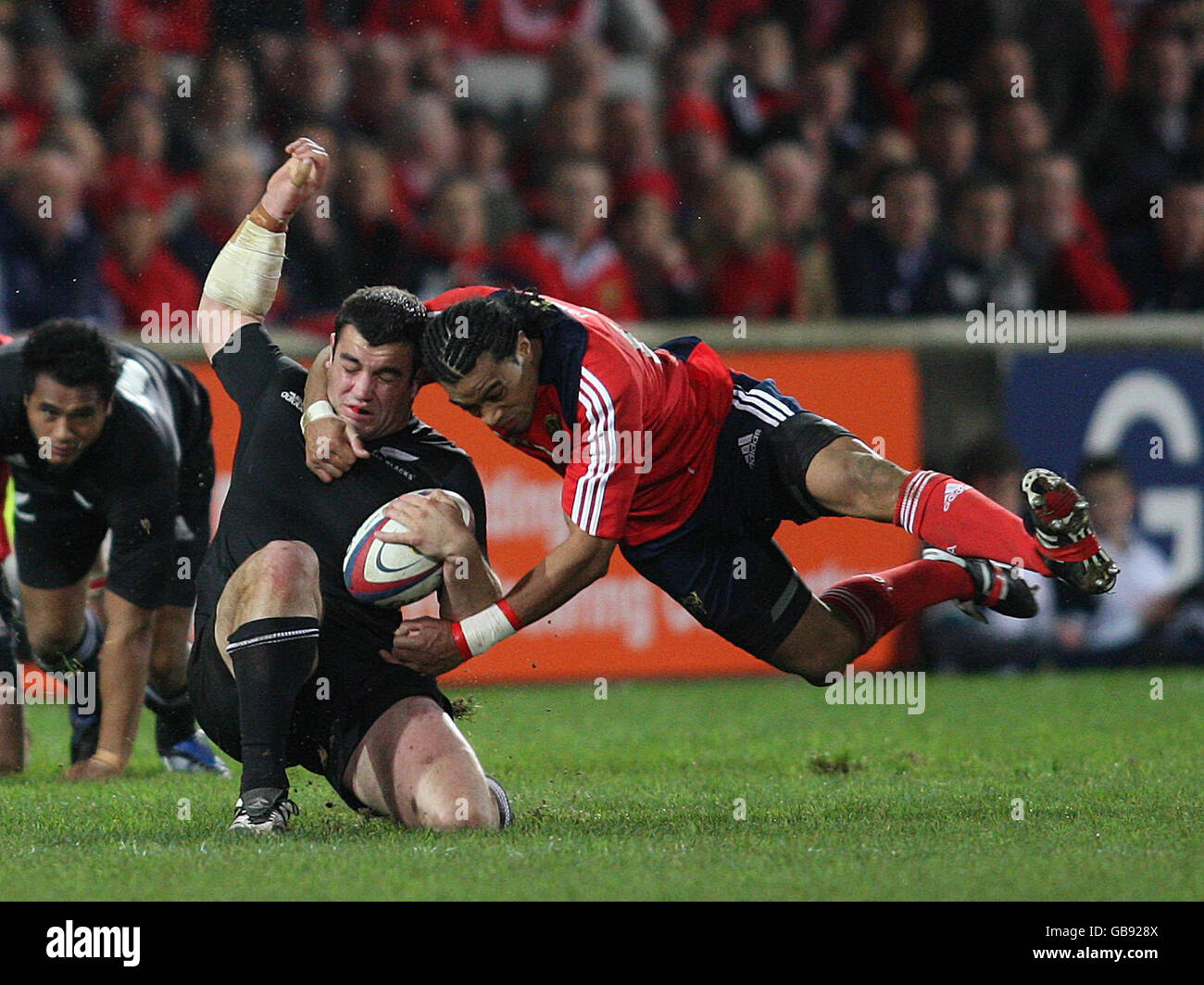 Munster's Lfeimi Mafi (right) tackles New Zealand's Corey Flynn during ...