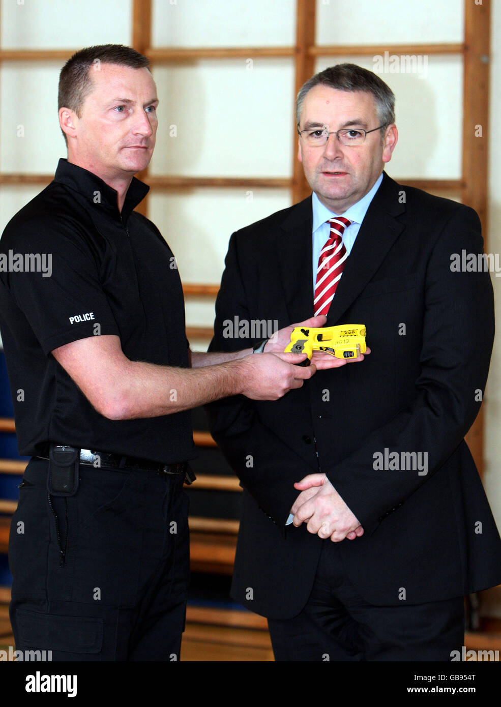 Councillor Alan Campbell, right, is shown a taser gun by a officer ...