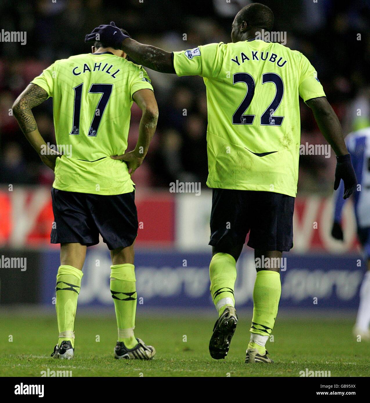 Everton's Tim Cahill is consoled by Ayegbeni Yakubu after missing a ...