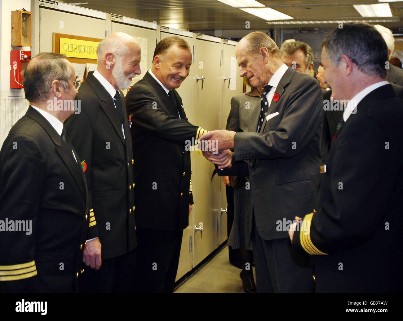 The Duke of Edinburgh, (2nd right) comments on the braid on an officers ...