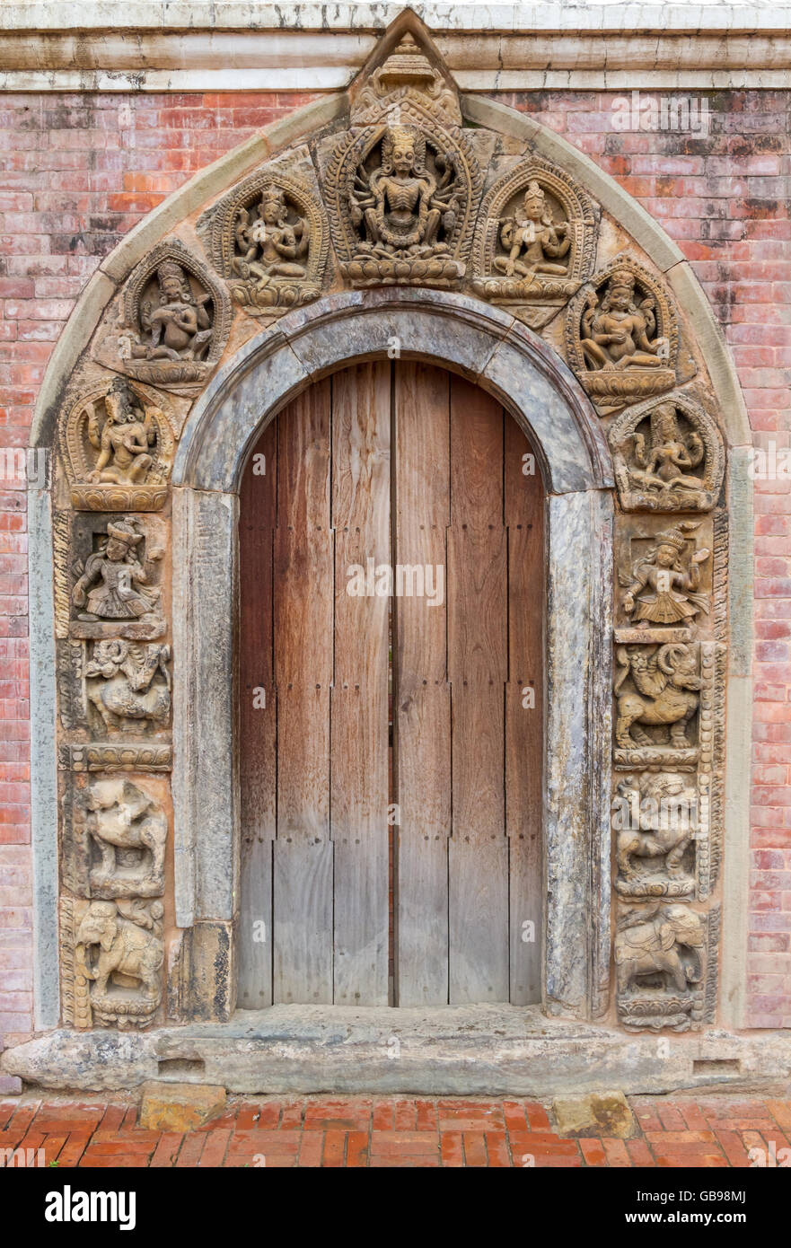 Vintage artistic wooden door with different nepalese sculpture in Patan ...