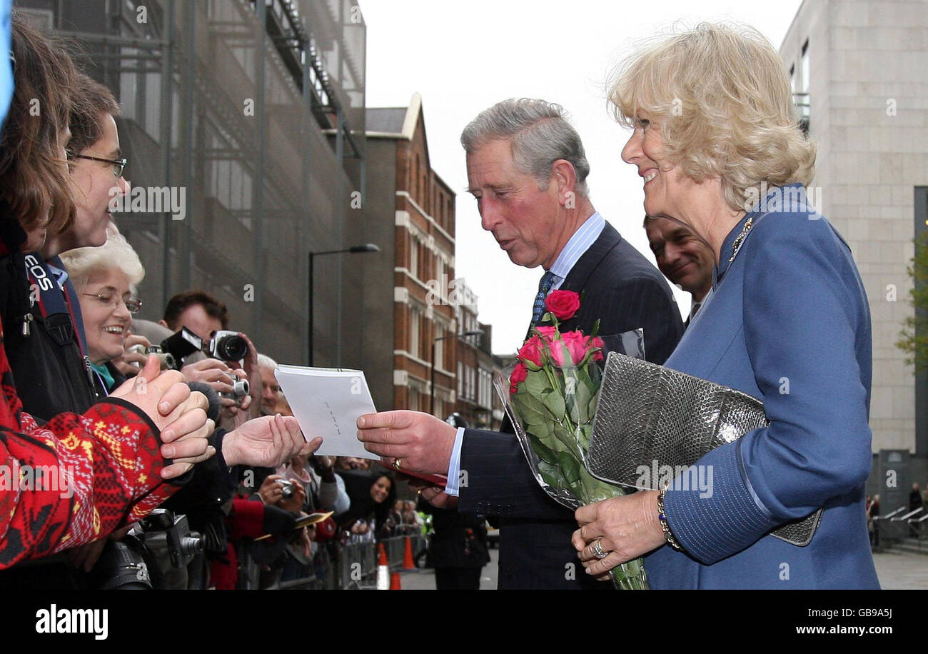 The Prince of Wales and the Duchess of Cornwall receive flowers from ...