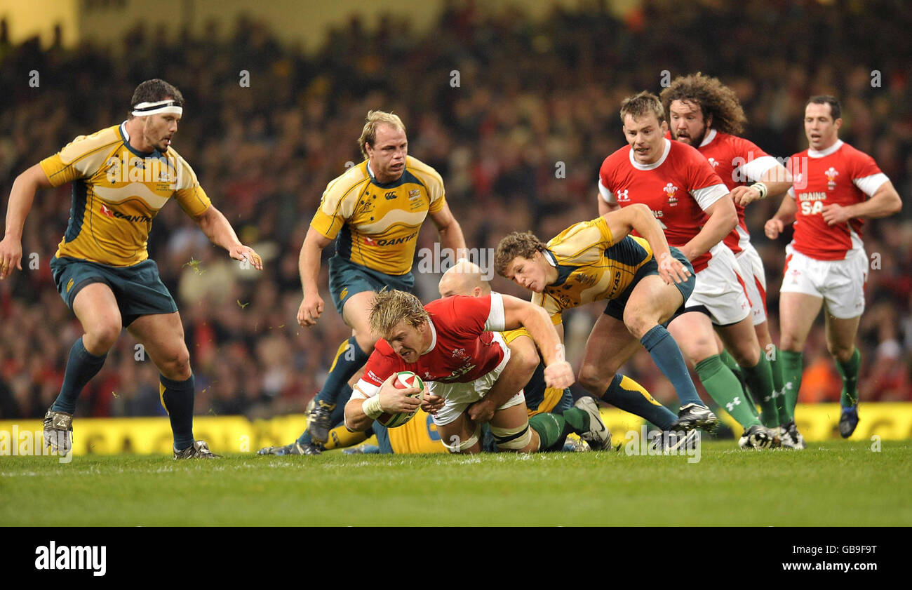Wales' Andy Powell is brought down by Australia's Stephen Moor during ...