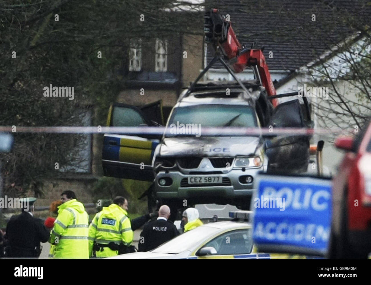 Emergency services remove a police vehicle from the scene near ...