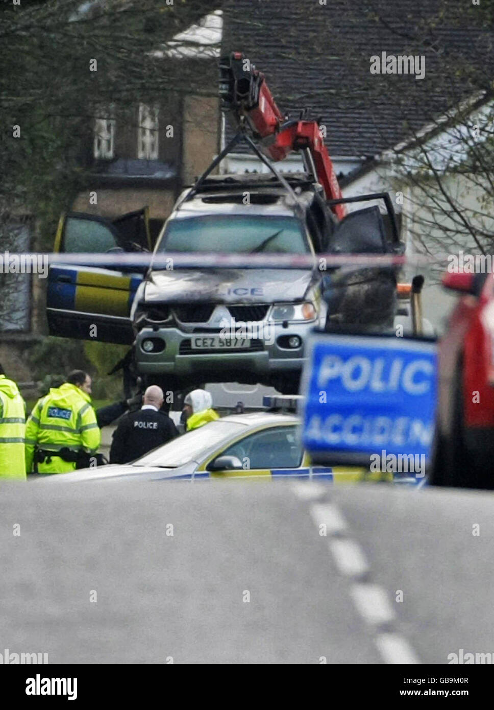 Emergency services remove a police vehicle from the scene near ...