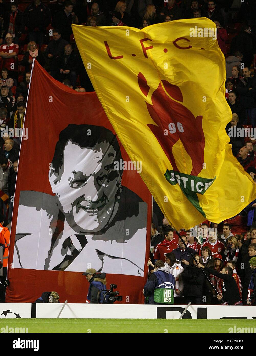 Liverpool fans show their support by waving large flags hi-res stock ...
