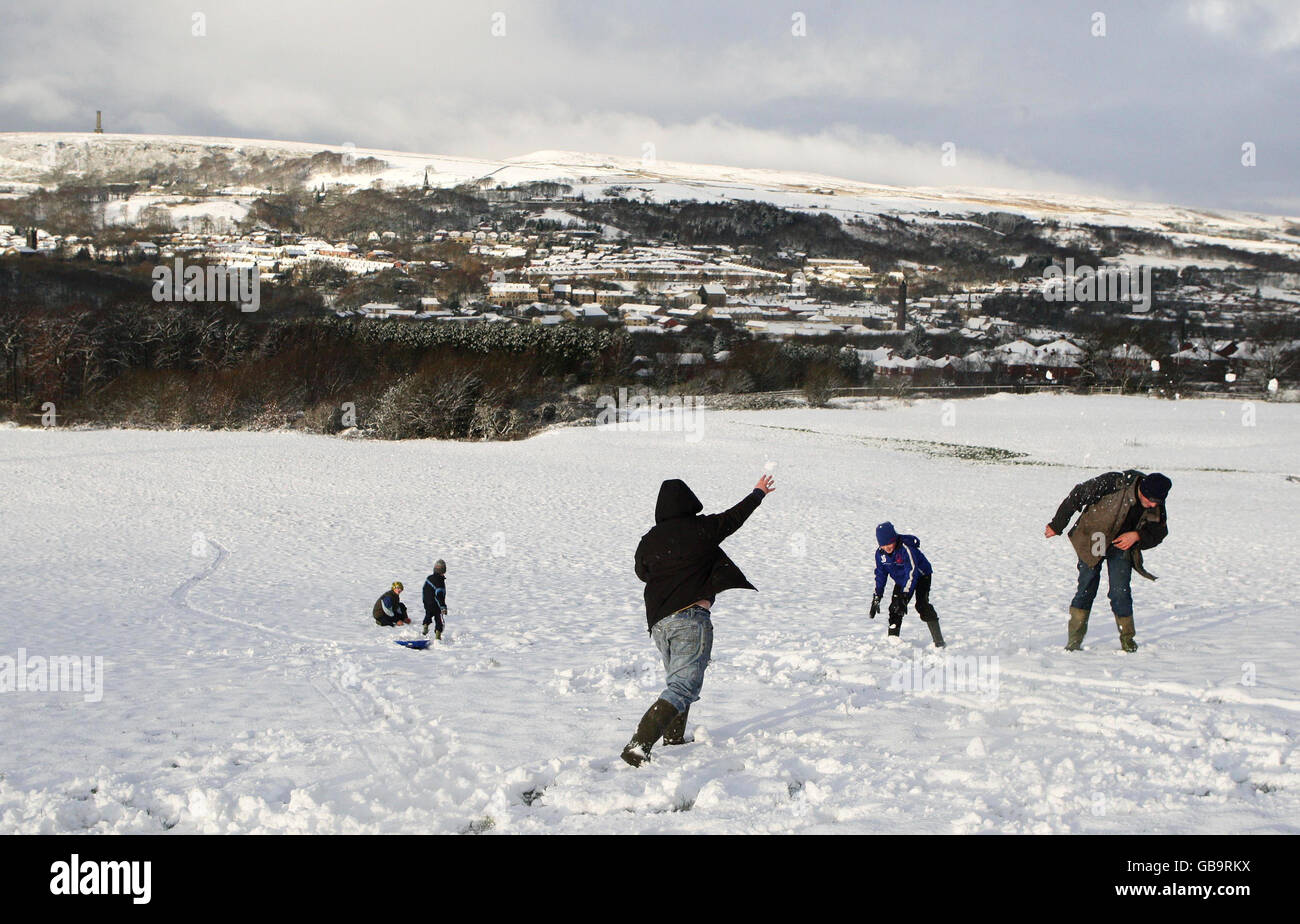 Children play in a field covered in snow in Ramsbottom near Bury ...