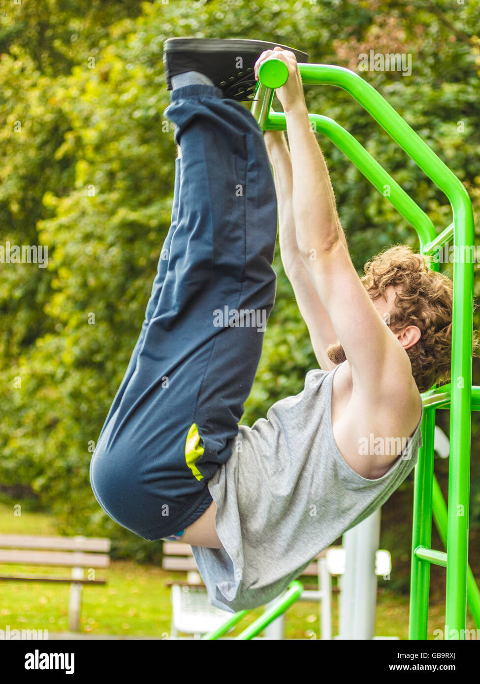 Active young man exercising on ladder. Muscular sporty guy in training ...