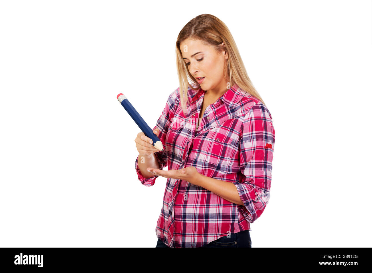 Young woman writing something big pencil Stock Photo - Alamy