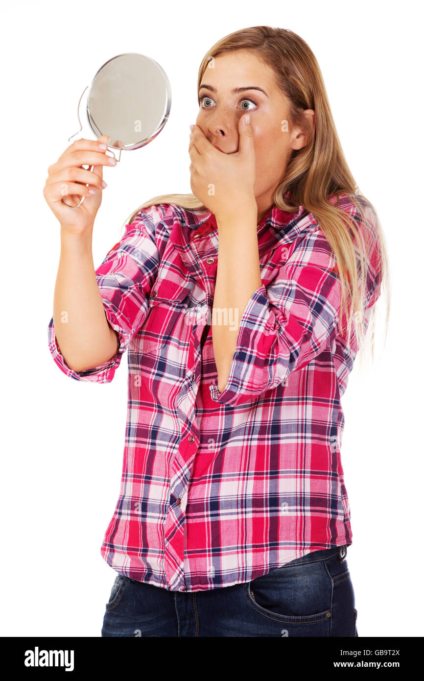 Shocked woman looking into mirror Stock Photo - Alamy