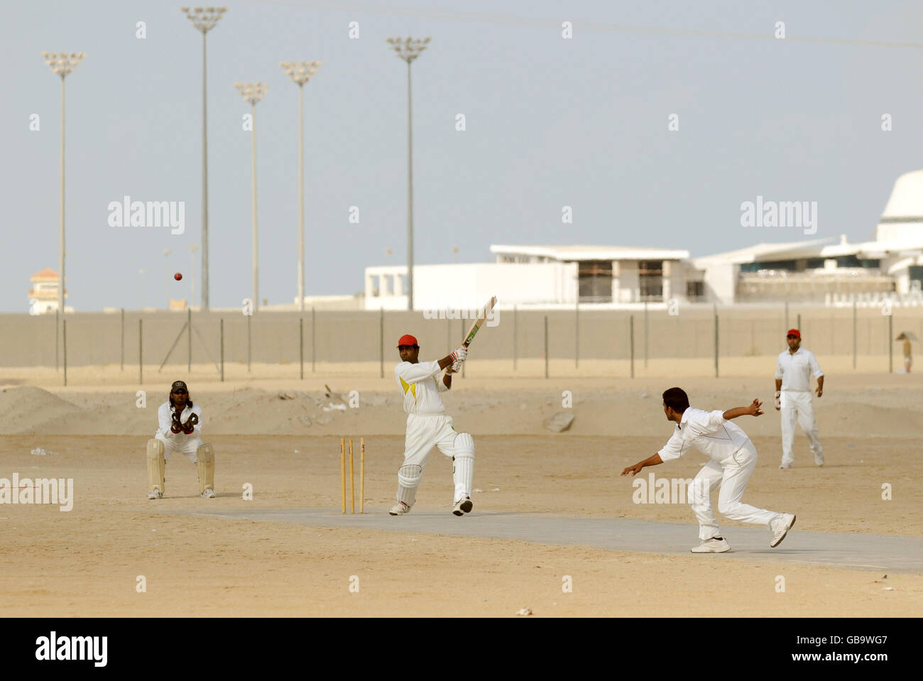 Local cricket teams play a match in the desert outside the Sheikh Zayed ...