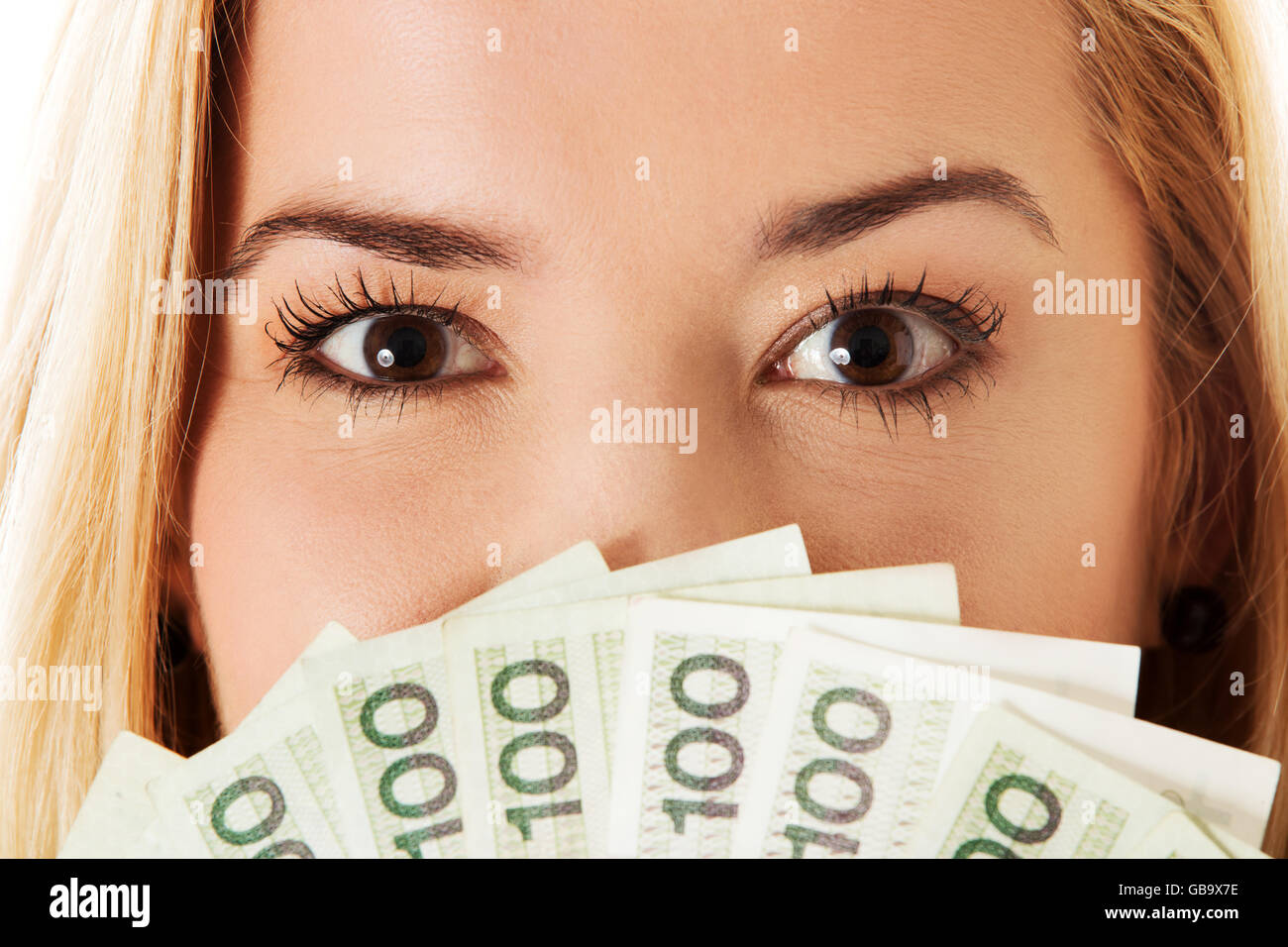 Attractive young lady holding cash and happy smiling over white ...