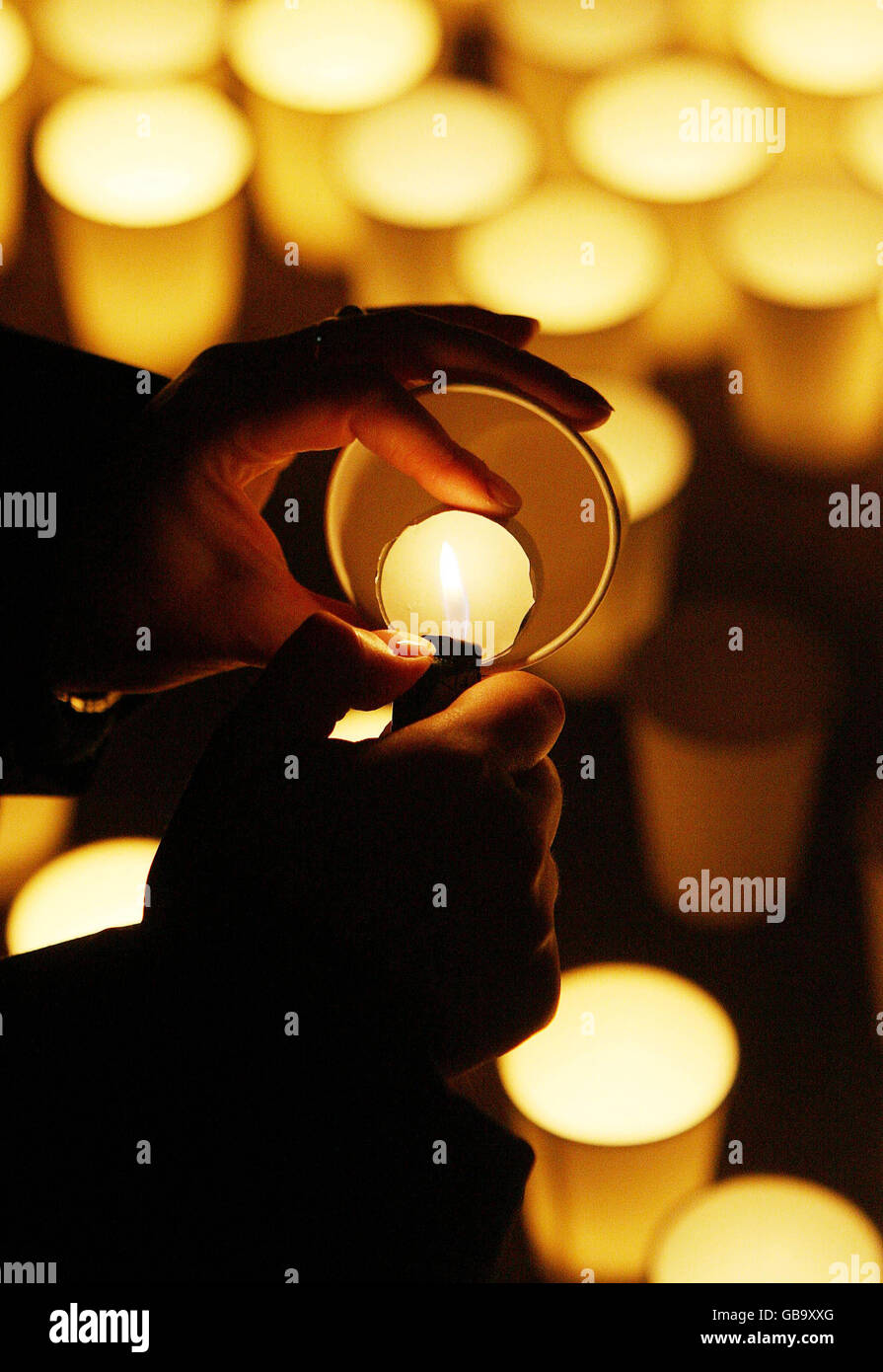 Lighting candles during vigil hi-res stock photography and images - Alamy