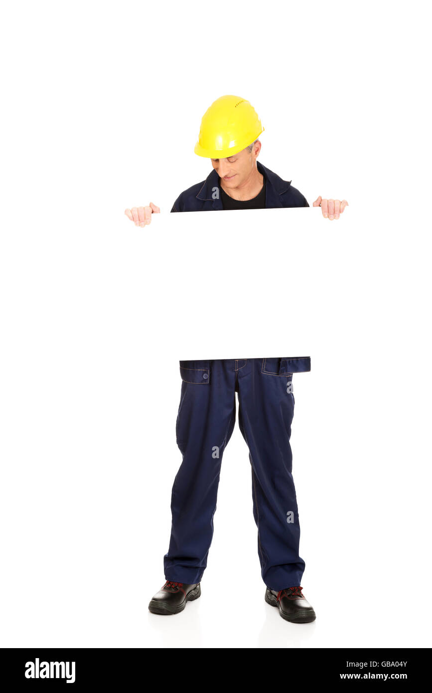 Happy worker presenting empty banner Stock Photo - Alamy