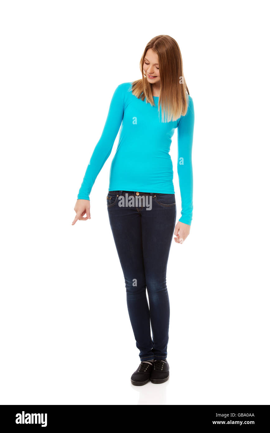 Young woman pointing down Stock Photo - Alamy