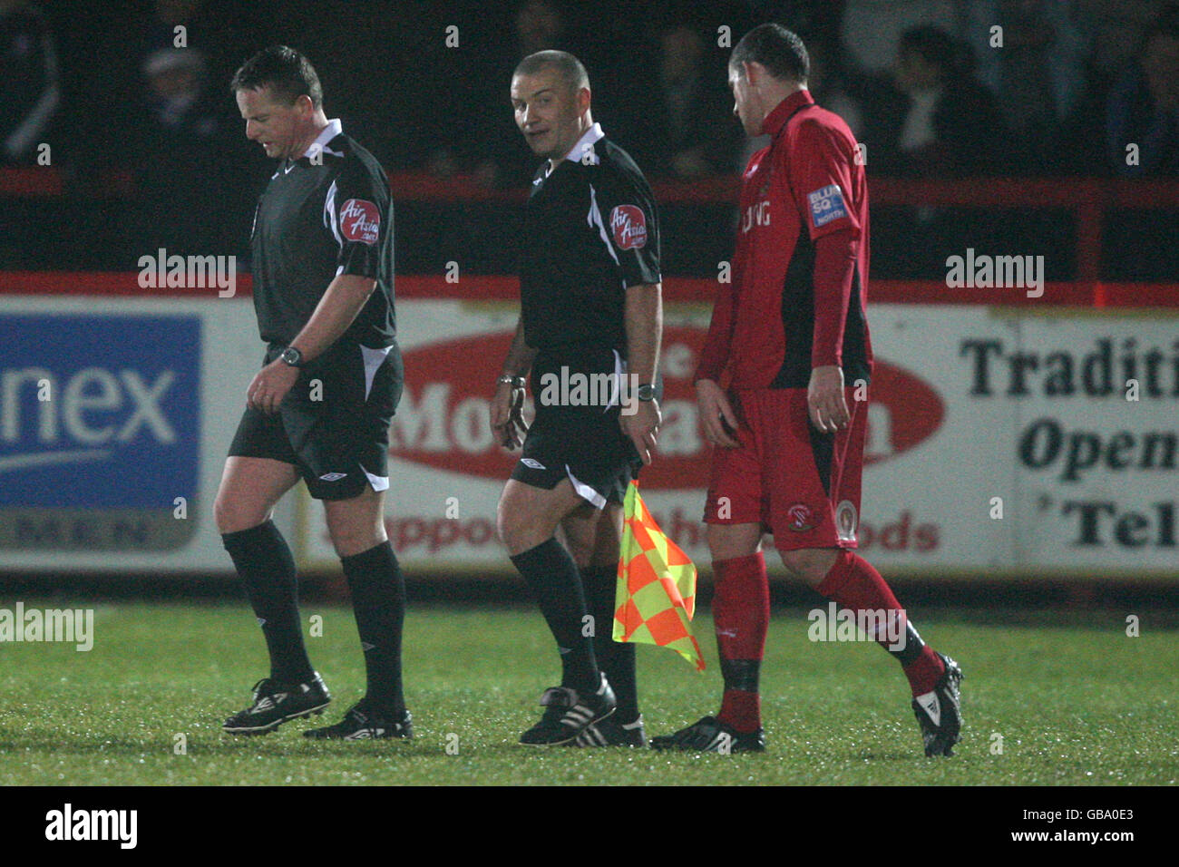 Droylsden's Sean Newton (right) looks at the back of assistant referee ...