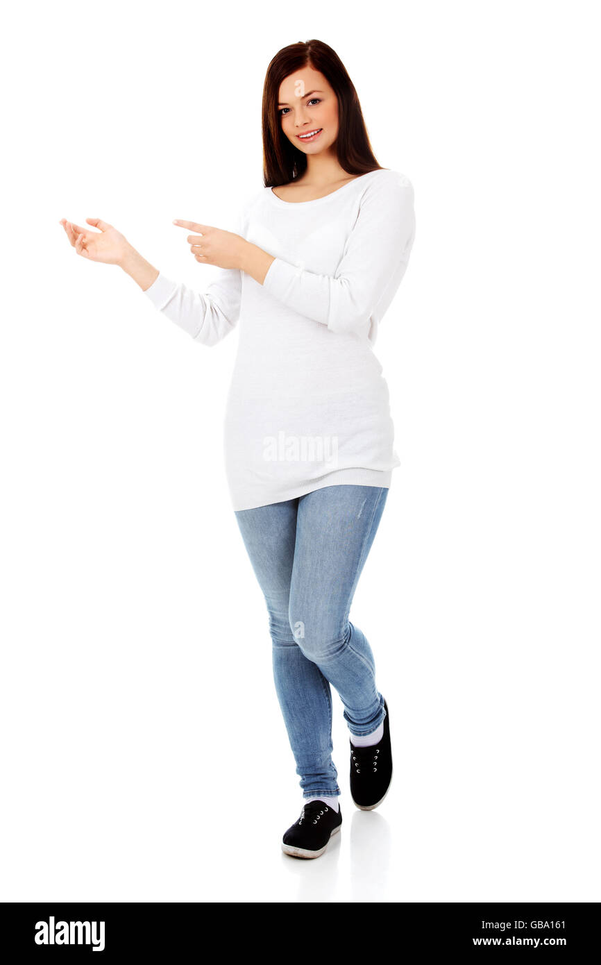 Smiling young woman shows something Stock Photo - Alamy