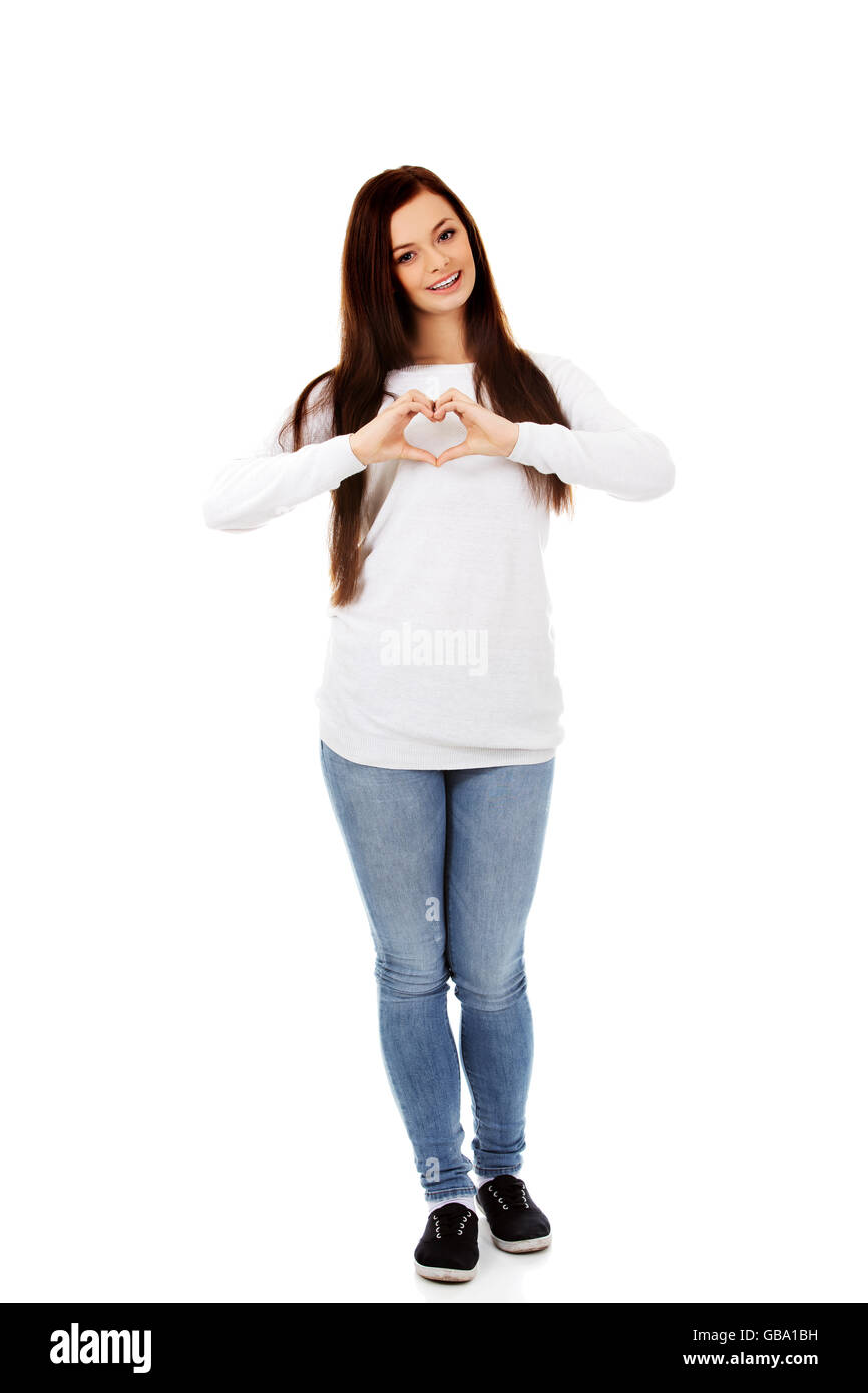 Beautiful young woman making a heart symbol with her hands Stock Photo ...