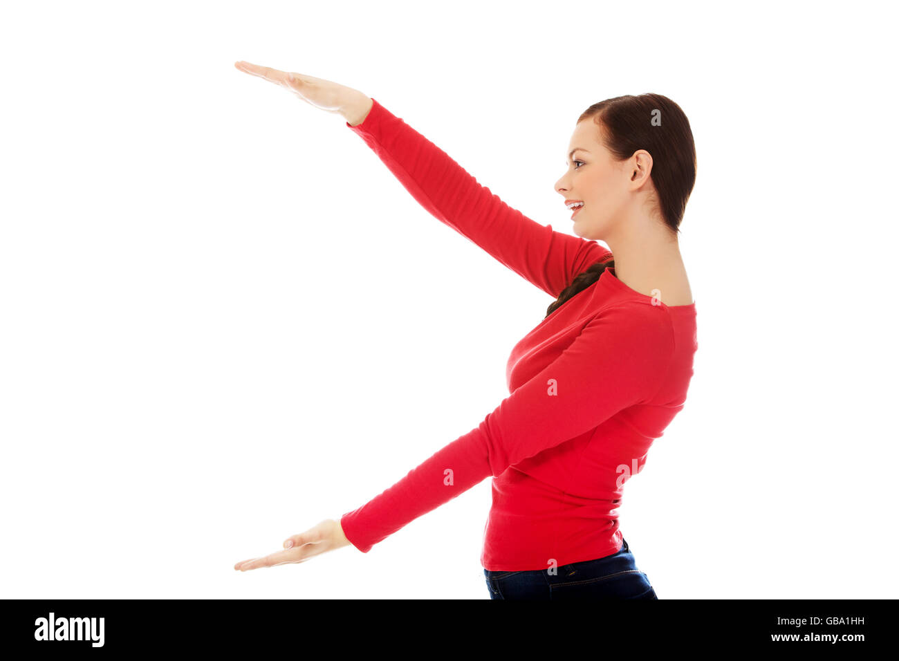 Young smiling woman presenting something Stock Photo - Alamy